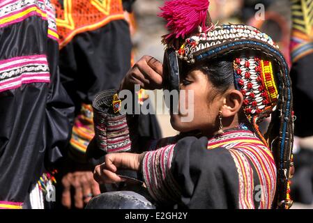 Kalash girl wearing a traditional headdress decorated with cowrie ...