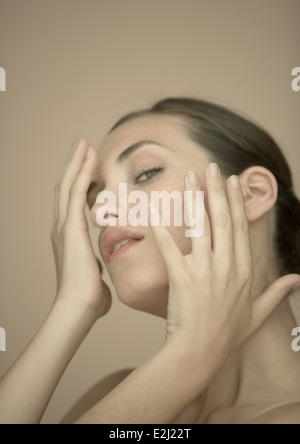Framing her gorgeous eyes. A young woman tweezing her eyebrows Stock ...