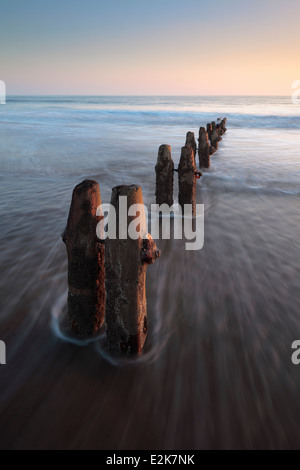 Groynes and surf at Sandsend near Whitby in North Yorkshire, England ...