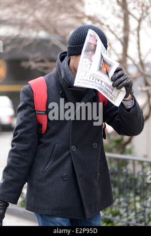 Jason Hoppy shields his face with The New York Post while out and about ...