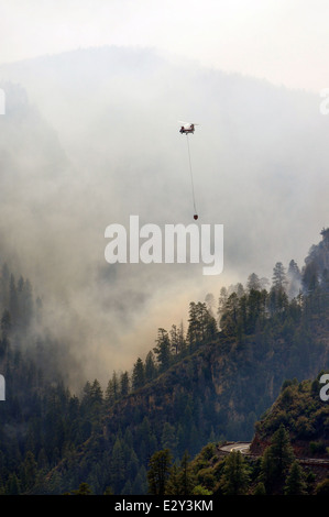 A helicopter performs a water drop to control the Slide Fire in Oak ...