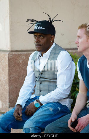 Rapper Coolio relaxes with a cigarette and a soft drink while filming ...