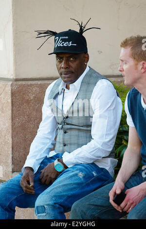 Rapper Coolio relaxes with a cigarette and a soft drink while filming ...