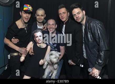 Members of the boyband 5ive hold a blow up doll with J's face stuck on ...