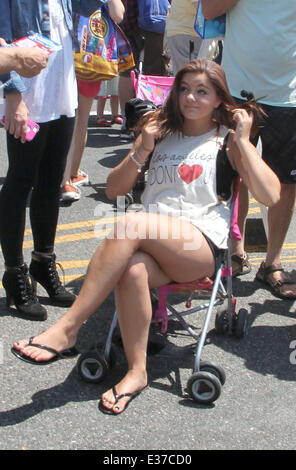 Ariel Winter takes a break to sit down in a stroller, as she enjoys a ...