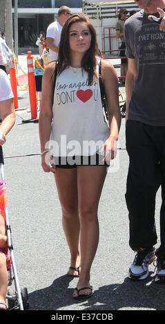 Ariel Winter takes a break to sit down in a stroller, as she enjoys a ...