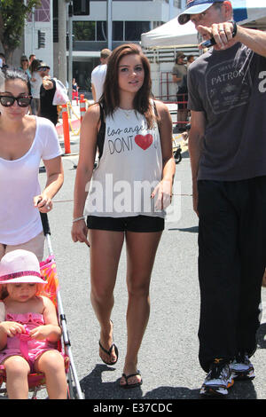 Ariel Winter takes a break to sit down in a stroller, as she enjoys a ...