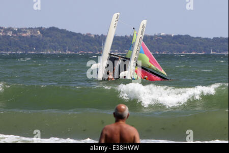 People watch at sinking catamaran yacht during a heavy wind storm at ...