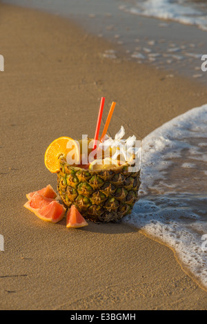 Fruity drink served inside a pineapple shell Stock Photo - Alamy