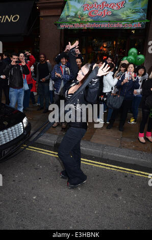 Circus performer from the Circus Of Horrors pulls a hearse with her ...