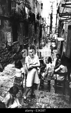 Children in Naples, Italy. Little boy helps one-legged companion across ...