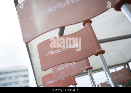 Flags on top of trolleys at the Media Markt are seen Stock Photo - Alamy