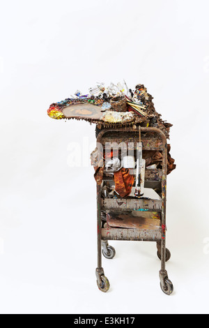 Artist's studio trolley with easel, palette and brushes on white ...