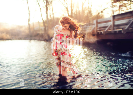Young woman knee deep in sea touching surface, Odessa, Ukraine Stock ...
