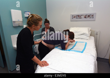 Pregnant person in labor with contractions giving birth while laying in ...