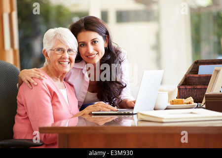 Mother and daughter at home face online lesson on laptop tired girl ...