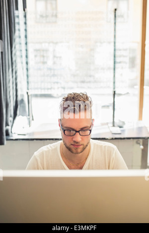 Young businessman using computer in office Stock Photo - Alamy