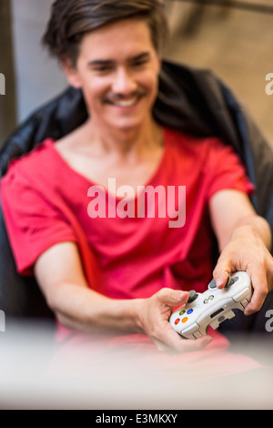 Young man playing video game against white background Stock Photo - Alamy