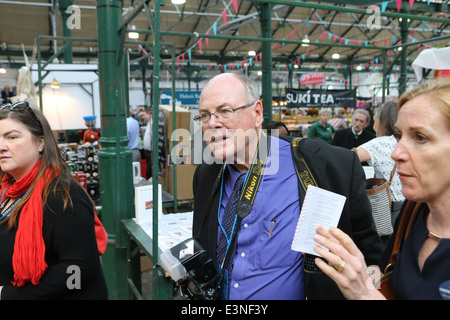 Royal Sun photographer Arthur Edwards shows the Duchess of Cornwall an ...