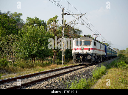 Green Indian Railways electric locomotive hauling container freight ...