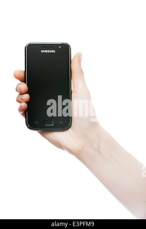 Hand holding cell phone with Samsung logo of TV and smartphone producer ...