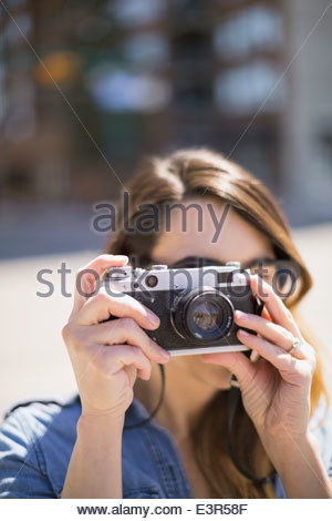 Close up of front view of a photographer woman eye photographing with a ...