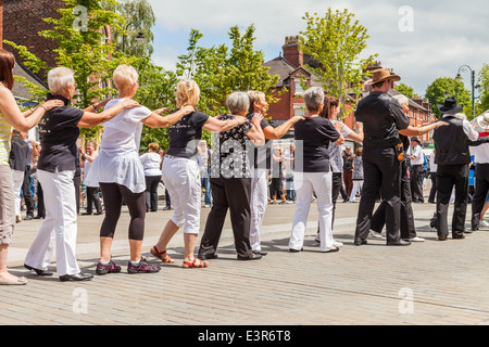 people line dancing in Leek town center. Leek, Staffordshire, England ...