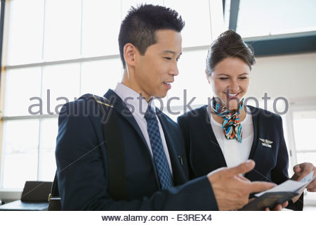 Customer service representative helping businessman with passport at ...
