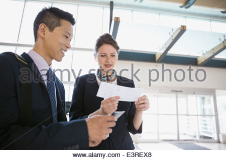 Customer service representative helping businessman with passport at ...