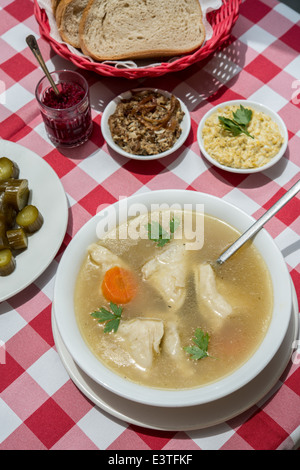 Traditional Jewish Kreplach soup with meat and carrot, gray background ...