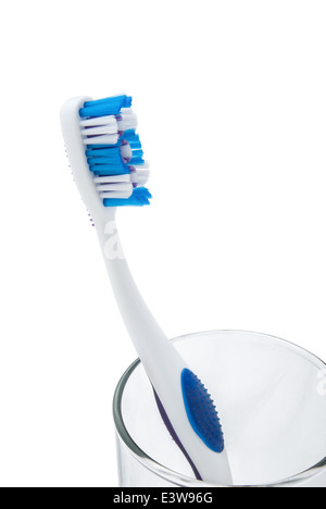 A toothbrush in a glass cup isolated on a white background. Care of ...