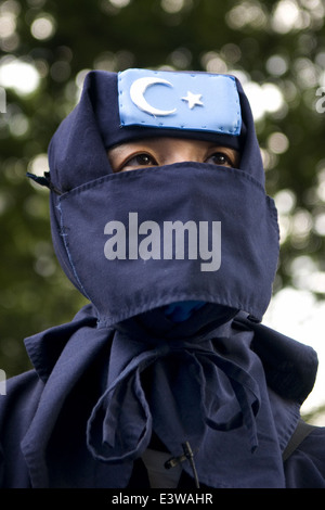 A veiled supporter of the Turkistan Islamic Movement (TIM) founded by ...