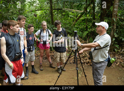 Group of teenage ecotourists on a rainforest ecology walk, Selva Verde ...