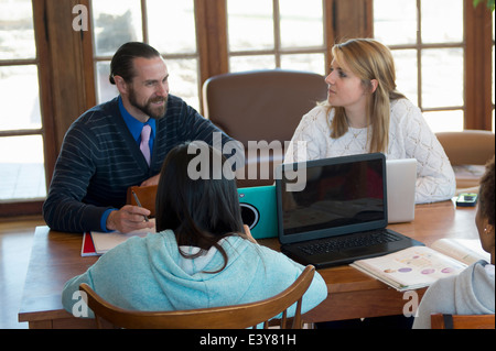 Young college students talking with teacher Stock Photo - Alamy
