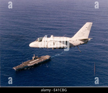 A photograph of a VQ-5 ES-3A aircraft flying over a desert landscape in ...