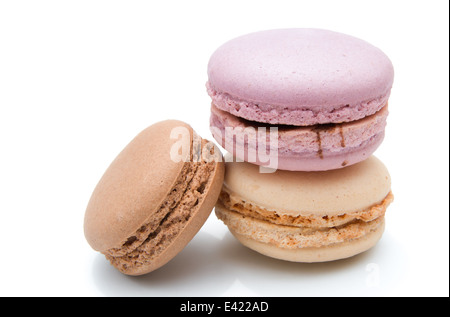 Three macaroons of pink color on yellow background, top view. Romantic ...