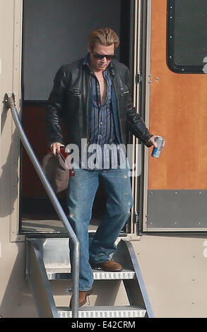 A clean shaven Johnny Depp shows a bit of paunch while leaving his ...