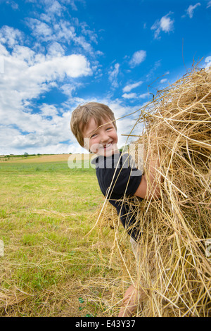 happy kid in summer straw hat making selfie on yellow background ...