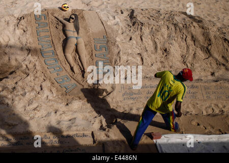 A man walks past a sand sculpture celebrating Canada’s first World Cup ...