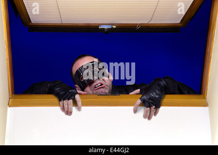 A robber enters the house through the roof window Stock Photo - Alamy