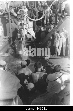 This image depicts a traditional crossing the equator ceremony on a ...