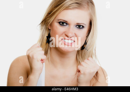Angry woman clenching her fists in frustration and looking up into the ...