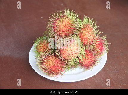Fresh rambutan fruit of peeling in dish on the foods table Stock Photo ...