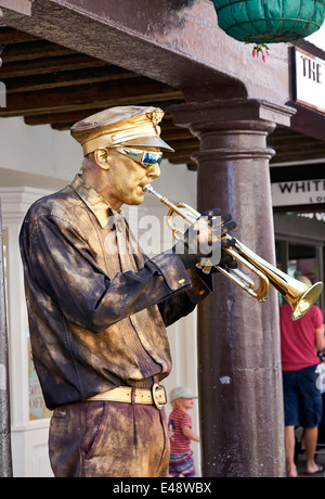 A trumpet playing human statue outside a Phones 4 U shop during ...