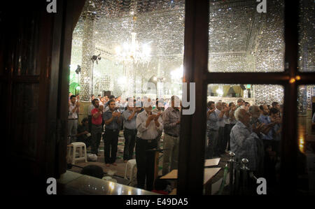 Tehran, Iran. 6th July, 2014. Muslims wait to break their fast during ...