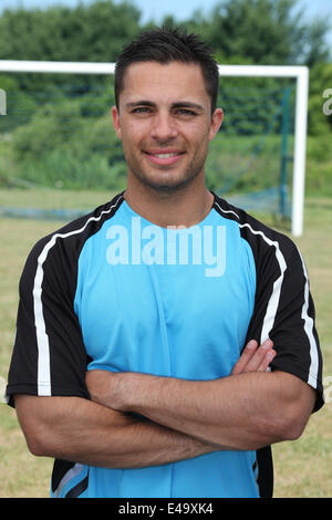 Football player stood on pitch Stock Photo - Alamy