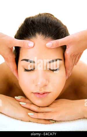 Young woman having facial massage with stone sticks in spa salon Stock ...