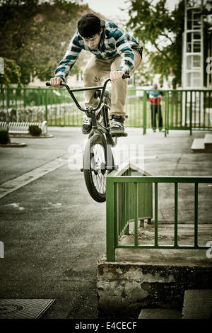 A man performs a stunt on a bicycle during a Superman Competition in Xi ...