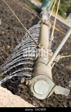 Sewage treatment plant works the rotating arm pours sewage over the ...