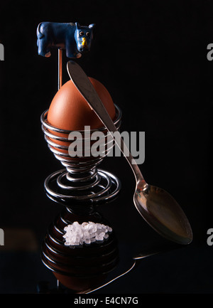 a silver metal spoon with too much salt in it on a marble table ...